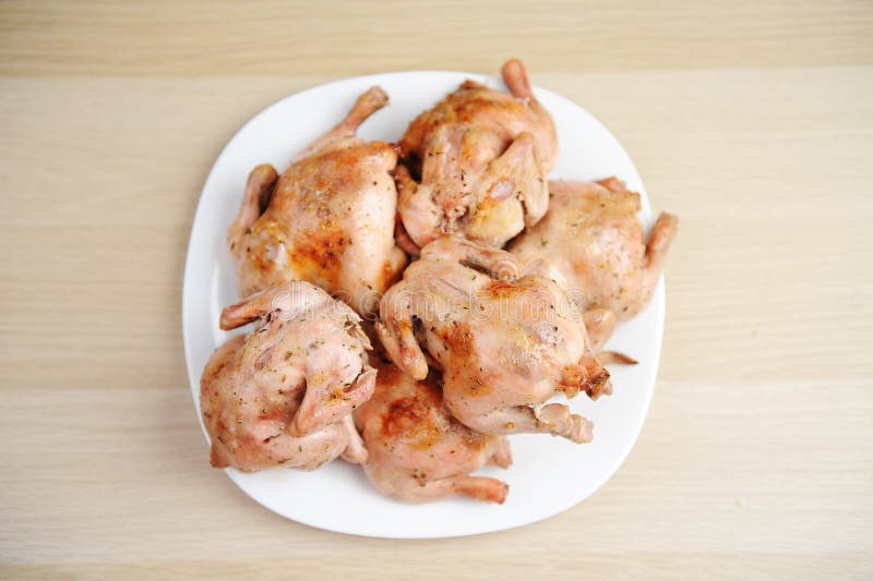 Six Baked Cornish Hens on White Plate Top View Stock Photo - Image of ...