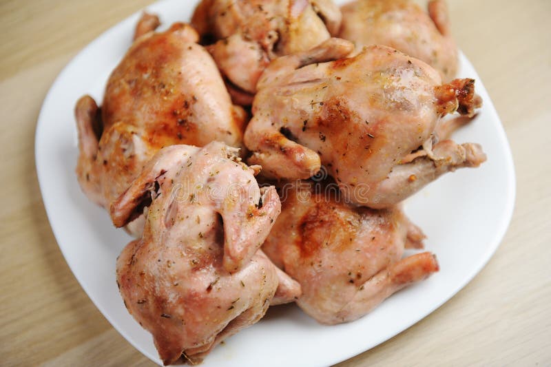 Six Baked Cornish Hens on White Plate Top View Stock Photo - Image of ...