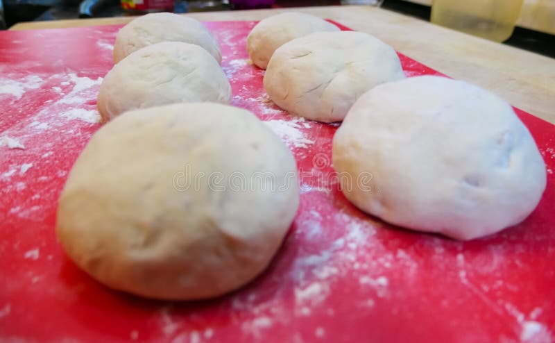 Six Balls of Raw Dough on Red Surface with Flour, Proofing for Baking ...