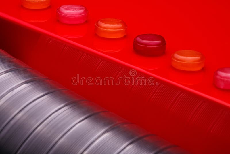 Six Candies Placed on Red Reflective Surface Stock Photo - Image of ...