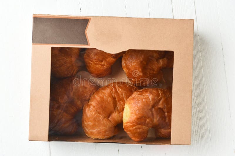 Six Croissant Rolls in a Bakery Box, on a Rustic White Wood Table Stock ...