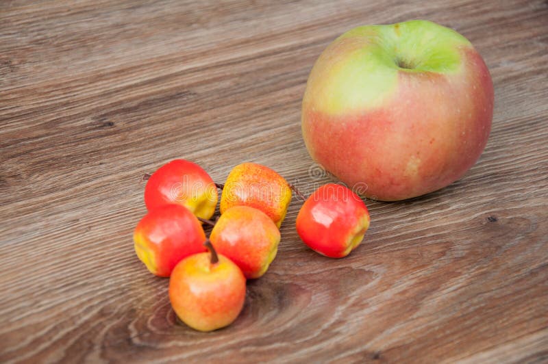 Six Small Apples and One Big on Table. Stock Photo - Image of ripe ...