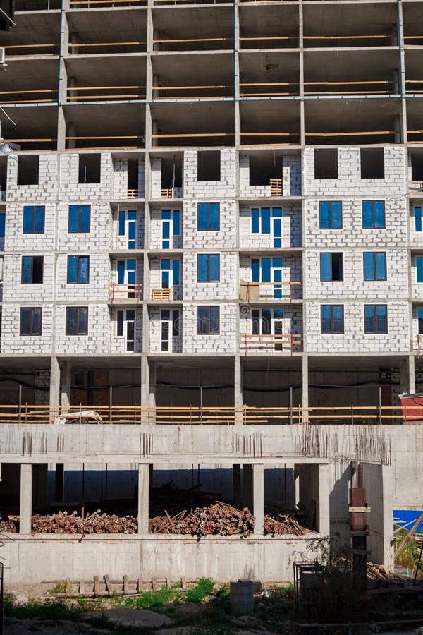Building Crane at the Background of a Multi-storey Building Under ...