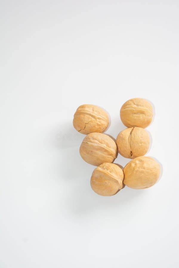 Six Walnuts are Arranged in a Staggered Pattern on a Pure White ...