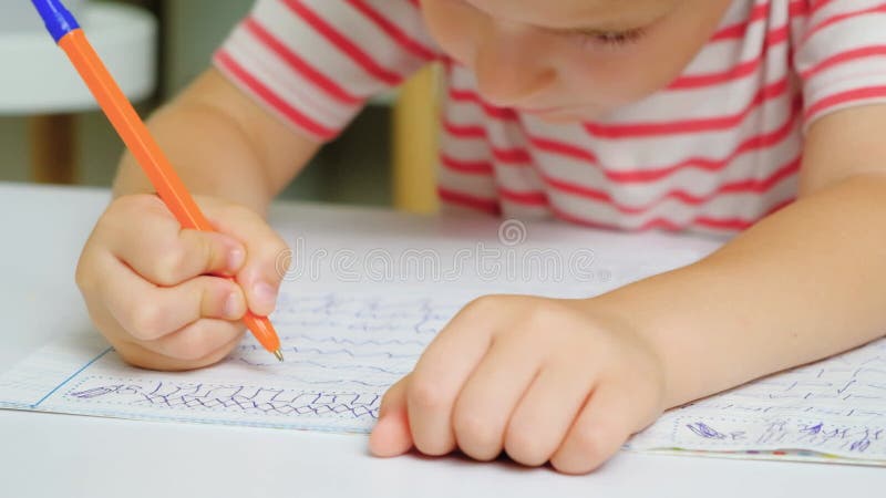A Six-year-old Boy Learns To Write, Hand and Write Close-up Stock ...