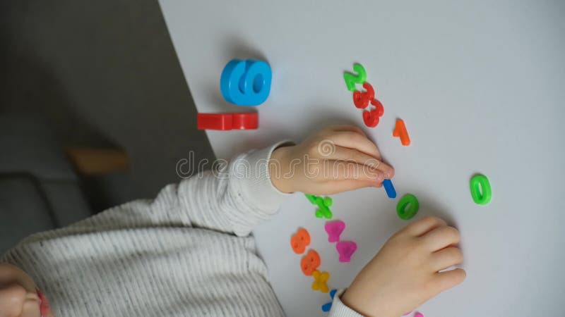 A Six-year-old Child Learns Math by Playing with Figures Numbers ...