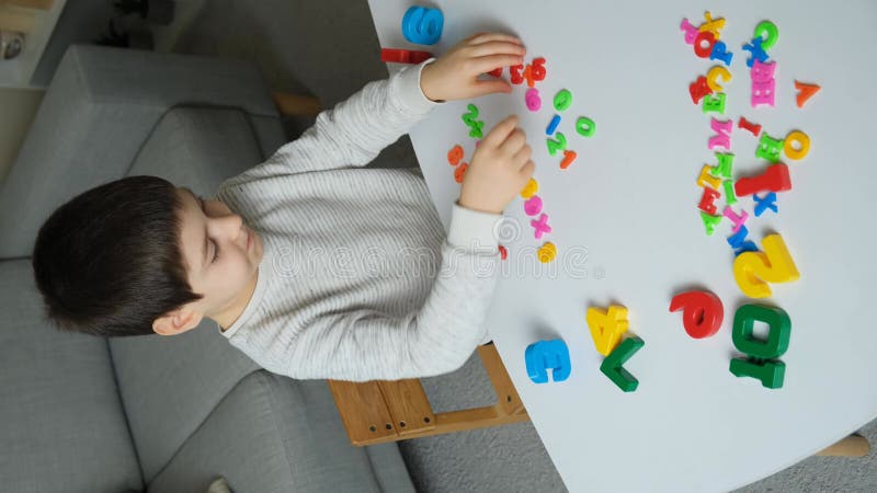 A Six-year-old Child Learns Math by Playing with Figures Numbers ...