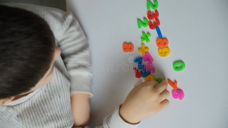 A Six-year-old Child Learns Math by Playing with Figures Numbers ...