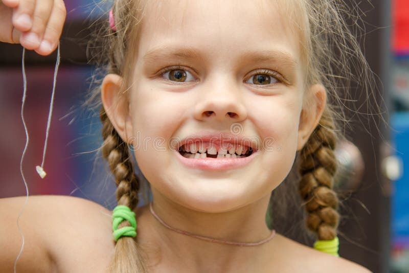 Six Year Old Girl Holding Her Lost Tooth on a String Stock Photo ...