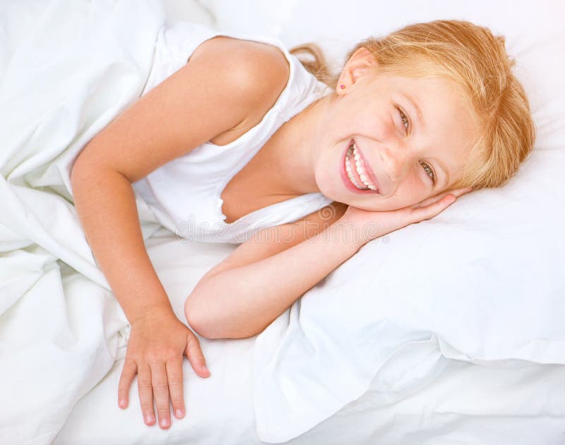 Girl lying in white bed stock photo. Image of pretty - 37555418