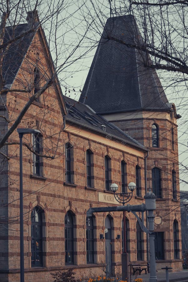 A Large Brick Building Featuring a Prominent Tower Situated on Its Top ...
