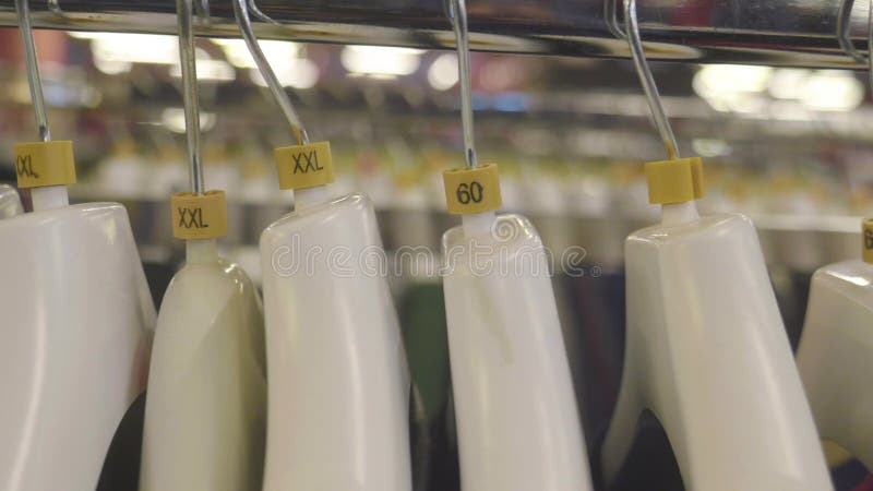 Size marker on the hanger. stock video. Video of rack - 306104507