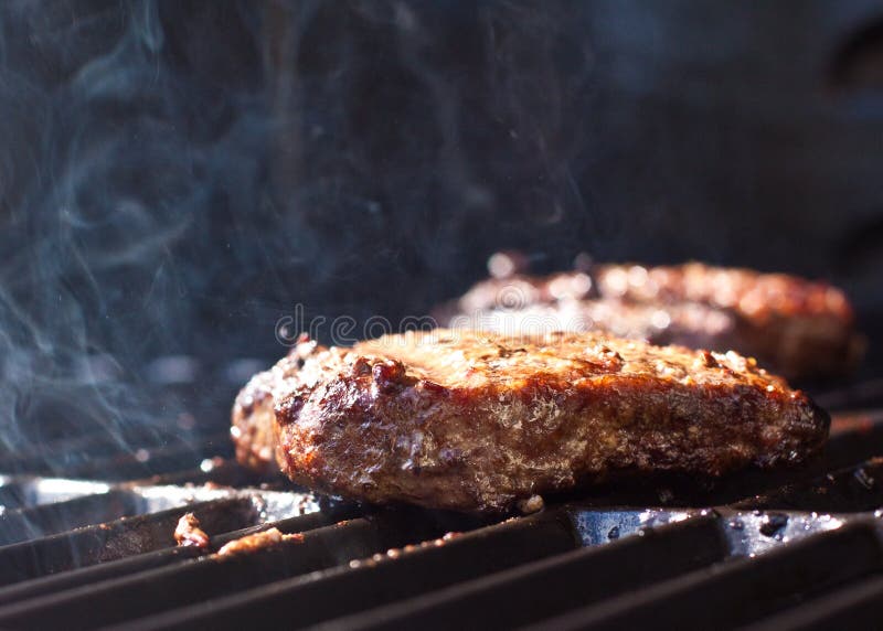 Sizzling Hamburgers on the Grill Stock Photo - Image of meat, sizzling ...