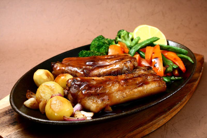 Sizzling Pork Dish stock photo. Image of iron, heat, onion - 14219466