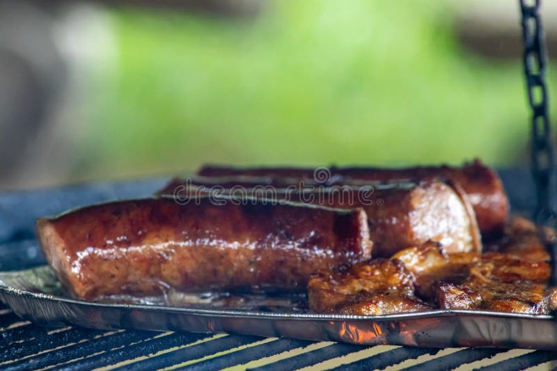 "Sizzling Sausage on a Open Barbecue Fire at Campsite." Stock Image ...