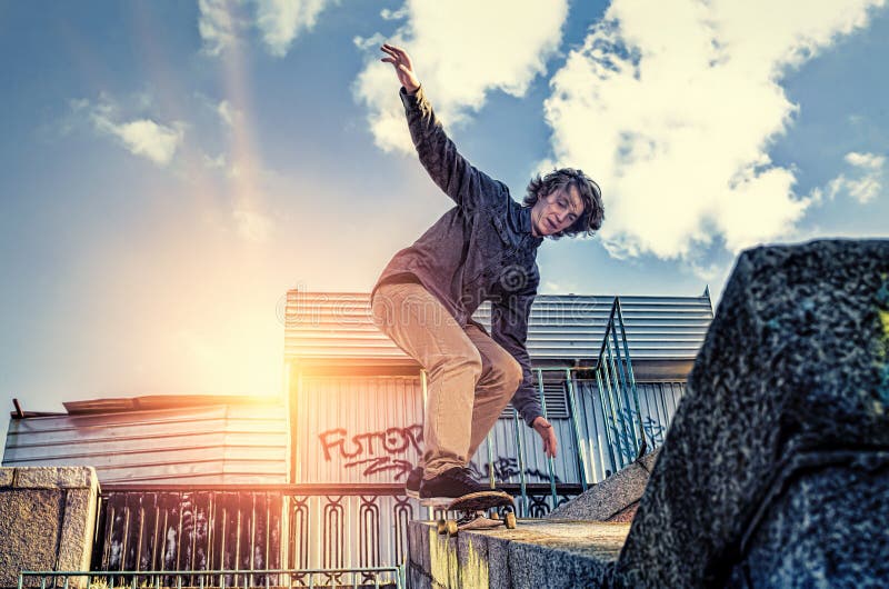 Skateboarder Doing a Skateboard Jumping Trick at Sunrise City Stock ...