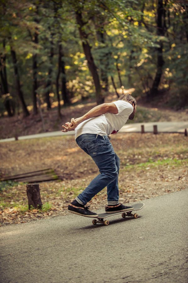 Skateboarder Riding a Skateboard Slope through the Forest Stock Photo ...