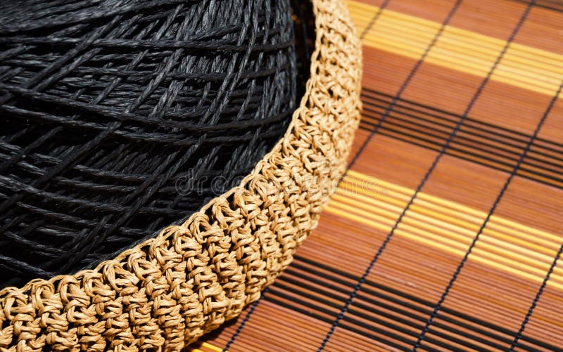 A Skein of Black Raffia in a Woven Bowl of Beige Raffia Stock Photo ...