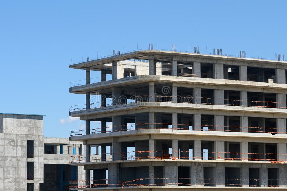 Construction Progresses on a Modern Multi-story Building Under a Bright ...