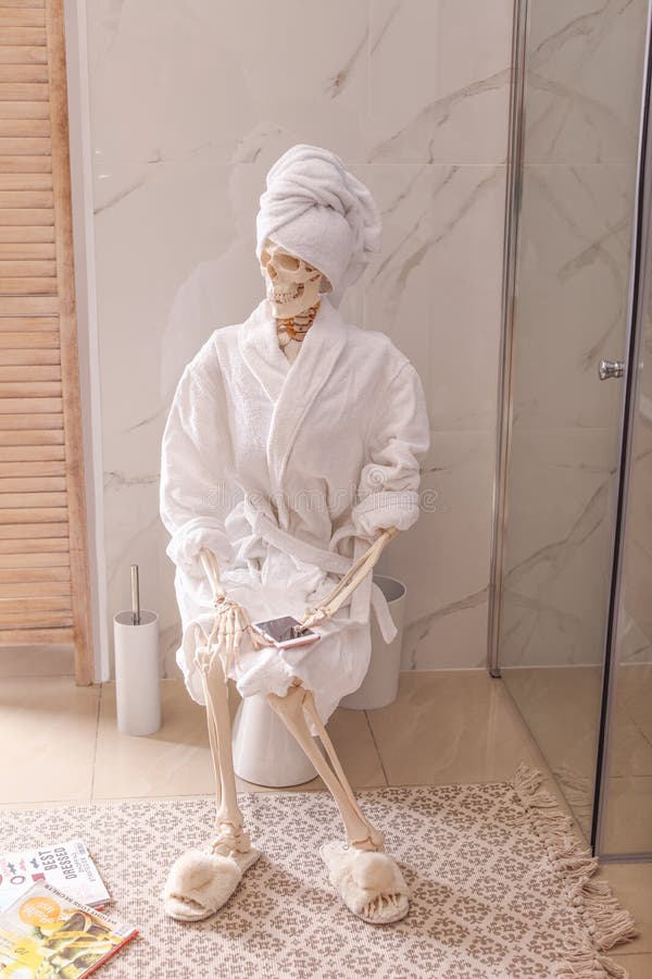 Skeleton in Bathrobe Sitting on Toilet Bowl Stock Image - Image of ...