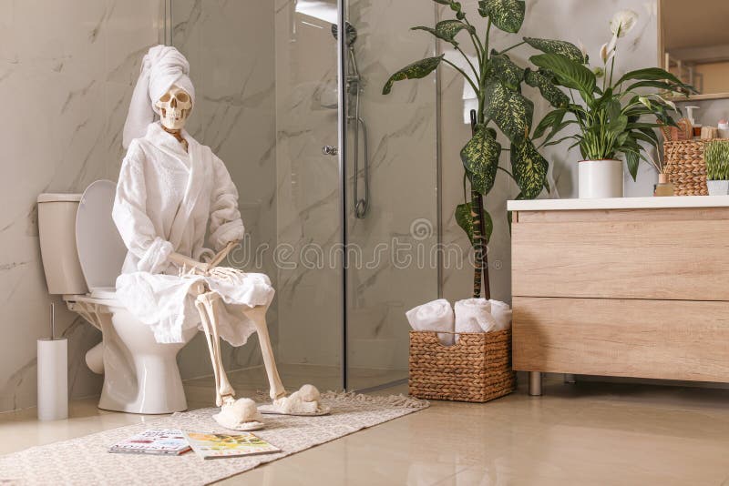 Skeleton in Bathrobe Sitting on Toilet Bowl Stock Image - Image of ...