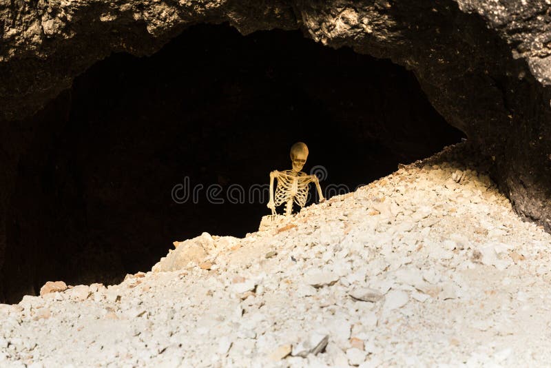 Skeleton in a Dark Cave in the Ground Crawling on Rocks Stock Image ...