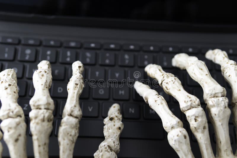 Skeleton Hands Typing a Report Using a Keyboard - Halloween Concept ...