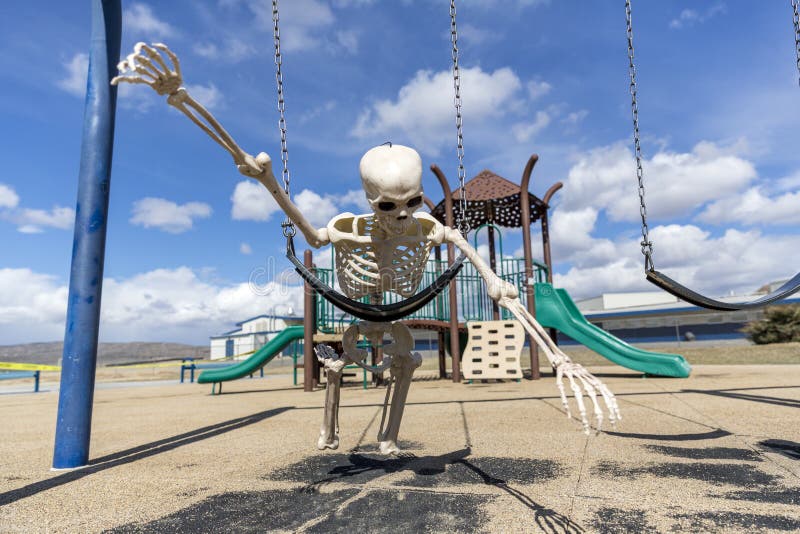 Skeleton Playing Superman on a Child S Swing in an Empty Park Stock ...