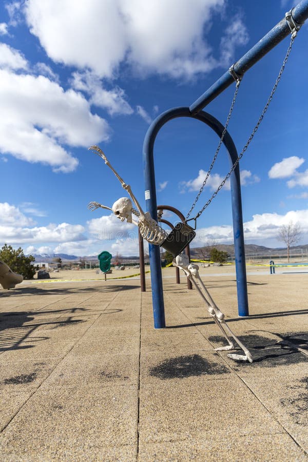 Skeleton Playing Superman on a Child S Swing in an Empty Park Stock ...