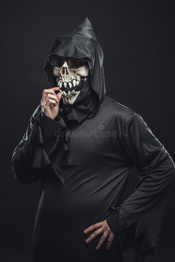 Skeleton in a Robe Picks His Teeth Stock Photo - Image of horror, mask ...