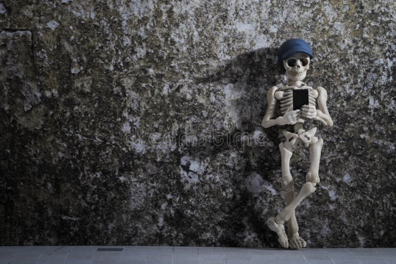 Skeleton with a smartphone stock photo. Image of flush - 75376790