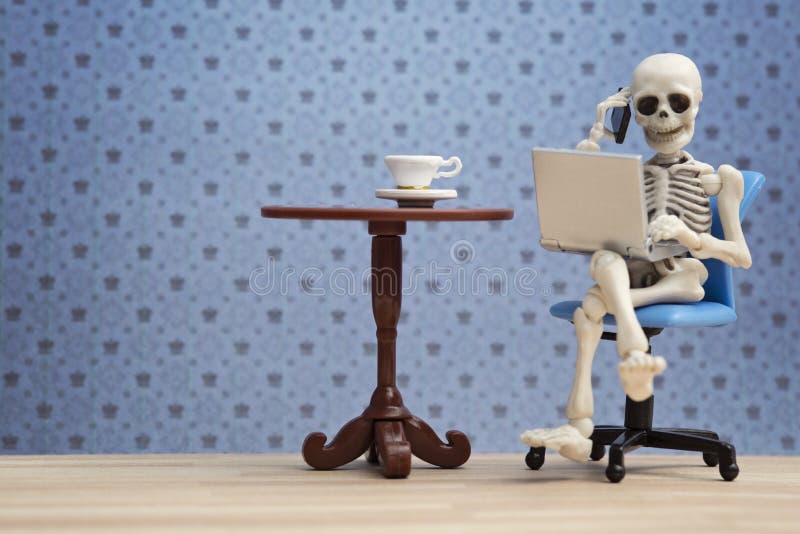 Skeleton with a smartphone stock image. Image of home - 75376729