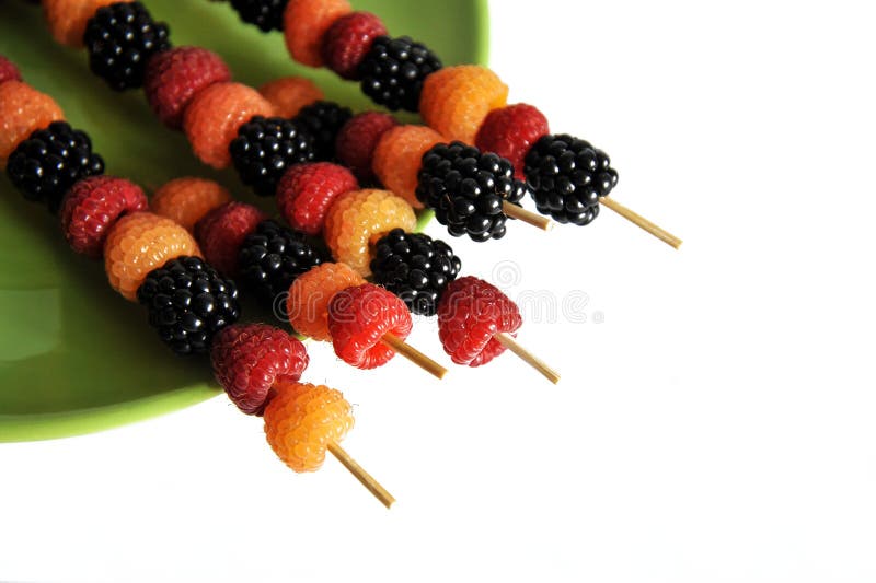 Skewers of Raspberry Berries of Different Colors on a Green Plate on a ...