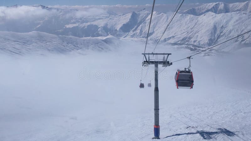 Ski Lift Over Clouds in Snowy Mountains Stock Photo - Image of vacation ...