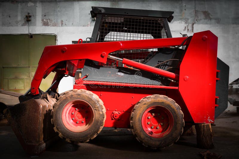 Skid loader in garage stock image. Image of bucket, gravel - 34648551