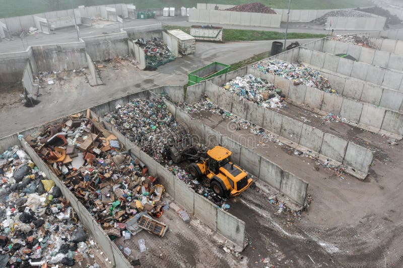 Moving a Pile of Waste with a Wheel Loader at the Landfill, Aerial View ...