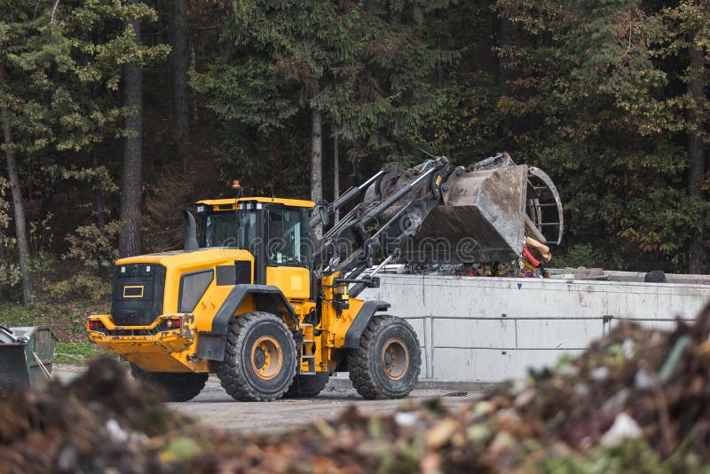 Moving a Pile of Waste with a Wheel Loader at the Landfill, Aerial View ...