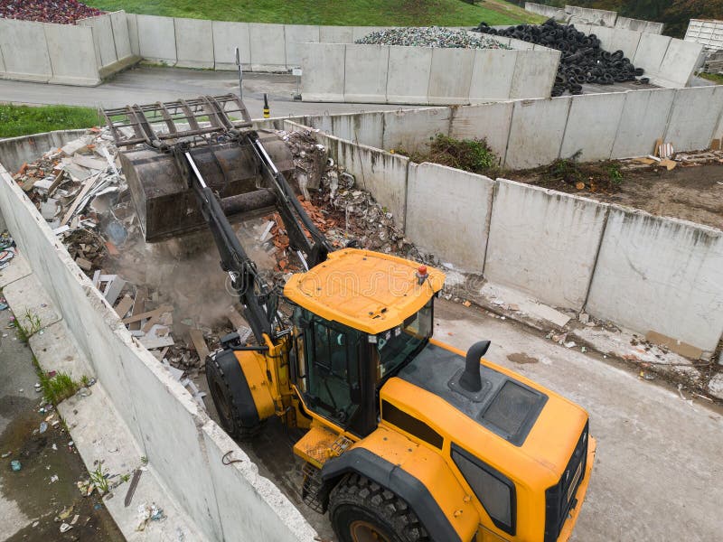 Skid Steer Loader Moving Waste Material, Shaking Out a Scrap Grapple ...