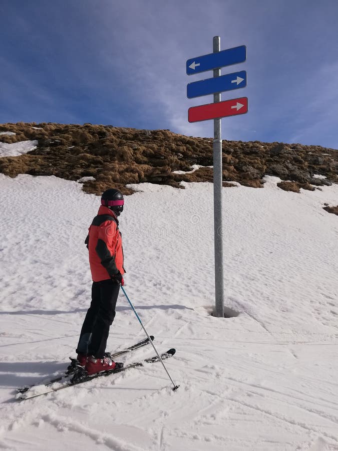 Skier Looking a Sign about the Level of Difficulty of the Slopes in a ...