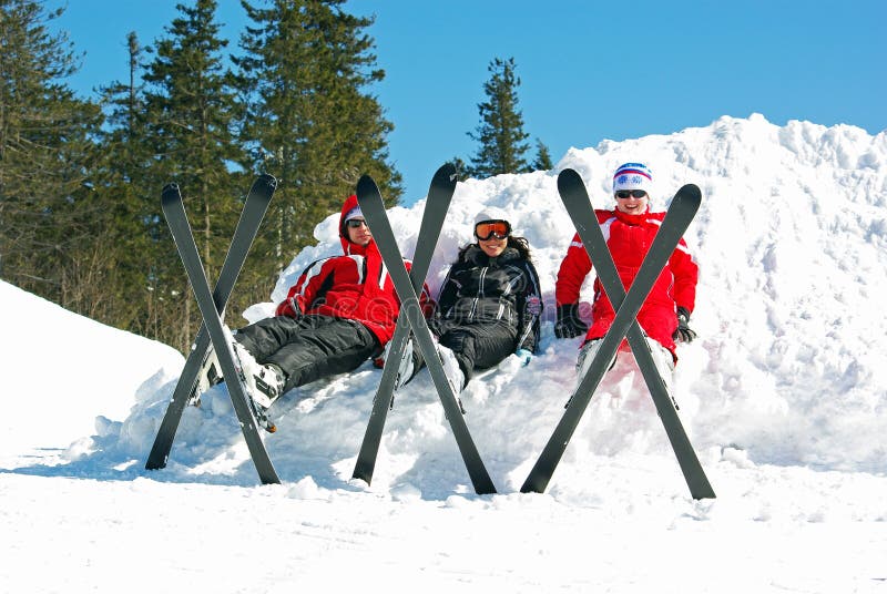 Three skiers stock image. Image of blue, laying, people - 9135713