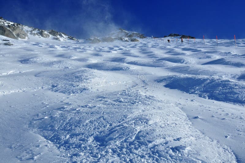 Skiers Crossing Onto a Mogul Field on a Glacier Stock Photo - Image of ...