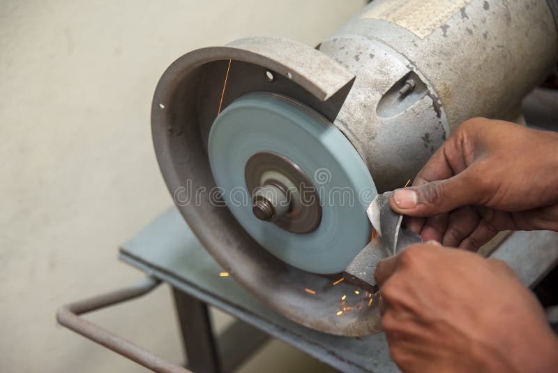 The Skill Operator Use Hand for Regrinding the Drill Tool with the ...
