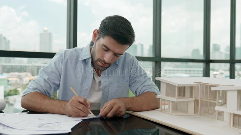 Skilled Architect Engineer Writing House Construction on Blueprint ...