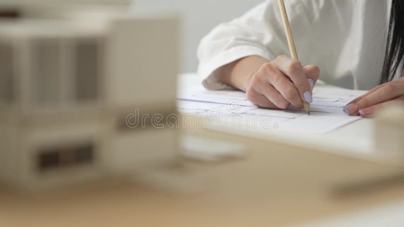 Skilled Architect Hand Writing Blueprint while Pointing House Model ...