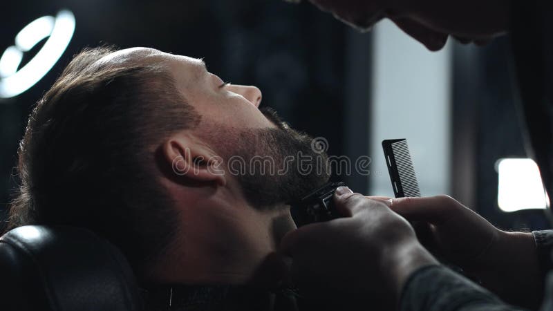 Skilled Barber Grooming Clients Beard Using Electric Razor, Delivering ...