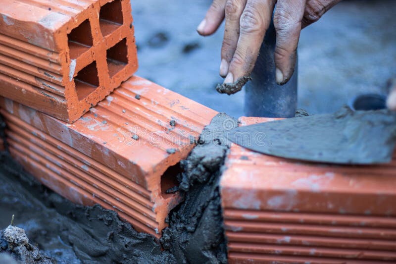 Skilled Bricklayer Worker Building a Red Brick Wall with Trowel and ...