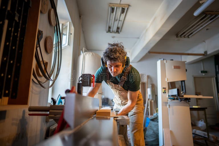 Skilled Carpenter Apply Full Attention To Precision Work on Jointer ...