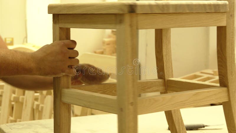 Professional Carpenter Sanding Wooden Chair with Sandpaper To Make the ...
