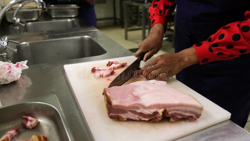 Skilled Chef Slicing Pork Belly in a Professional Kitchen Setup Stock ...