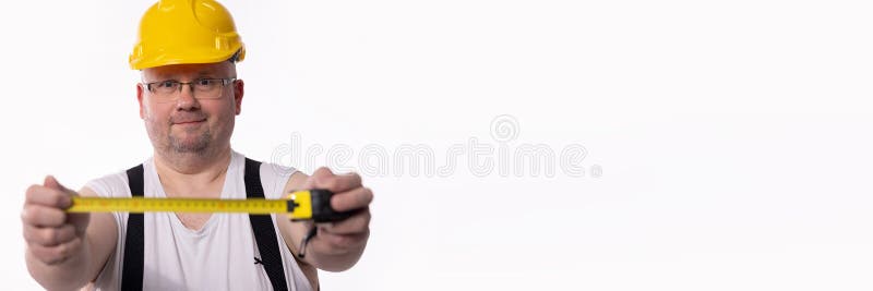 A Skilled Construction Worker is Measuring Dimensions Carefully Using a ...